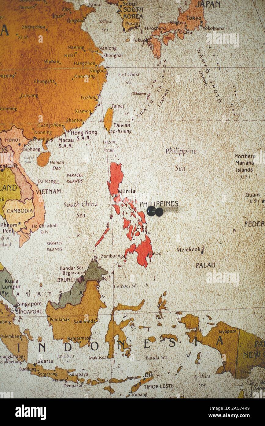 Vertical shot of a black pin on the Philippines country on the map ...