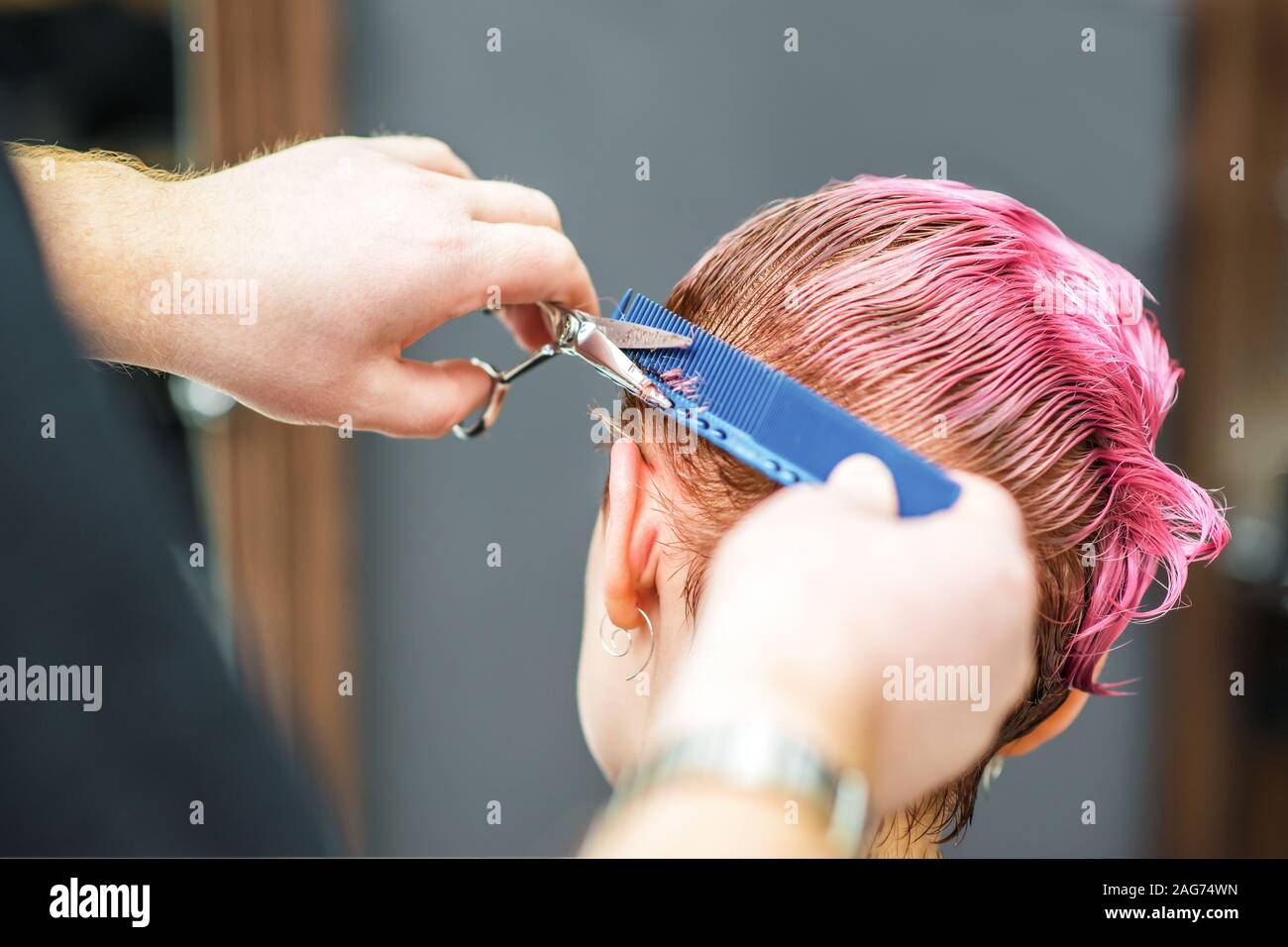 Hairdresser cutting short pink hair in beauty salon, close up Stock ...