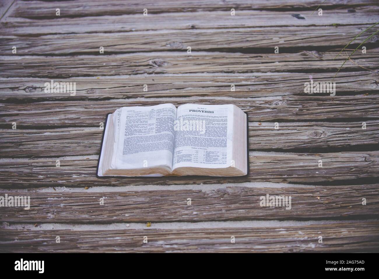Overhead shot of an open bible on a wooden pathway Stock Photo - Alamy