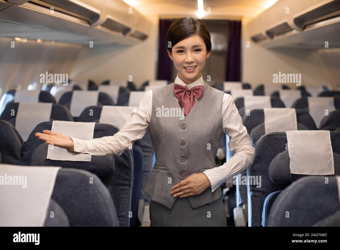 Smiling Chinese flight attendant Stock Photo - Alamy