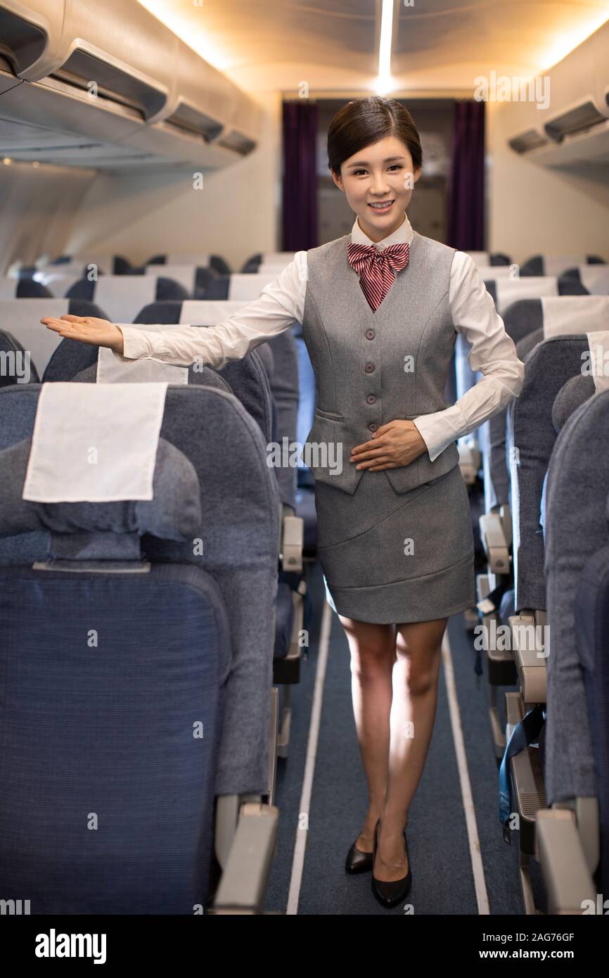 Smiling Chinese flight attendant Stock Photo - Alamy