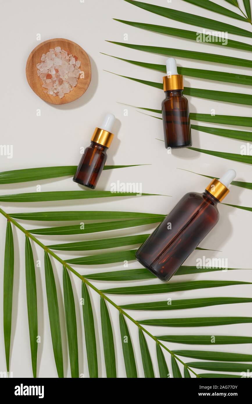 Cosmetic package containers with green leaves, pink salt. natural ...