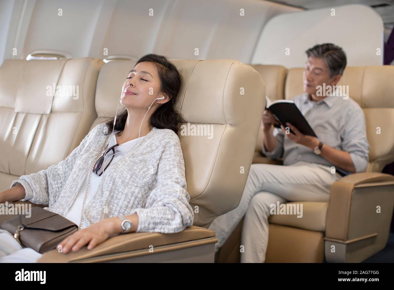 Chinese passengers on plane Stock Photo - Alamy