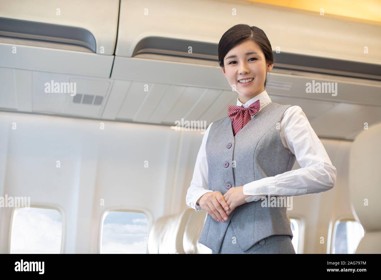 Smiling Chinese flight attendant Stock Photo - Alamy