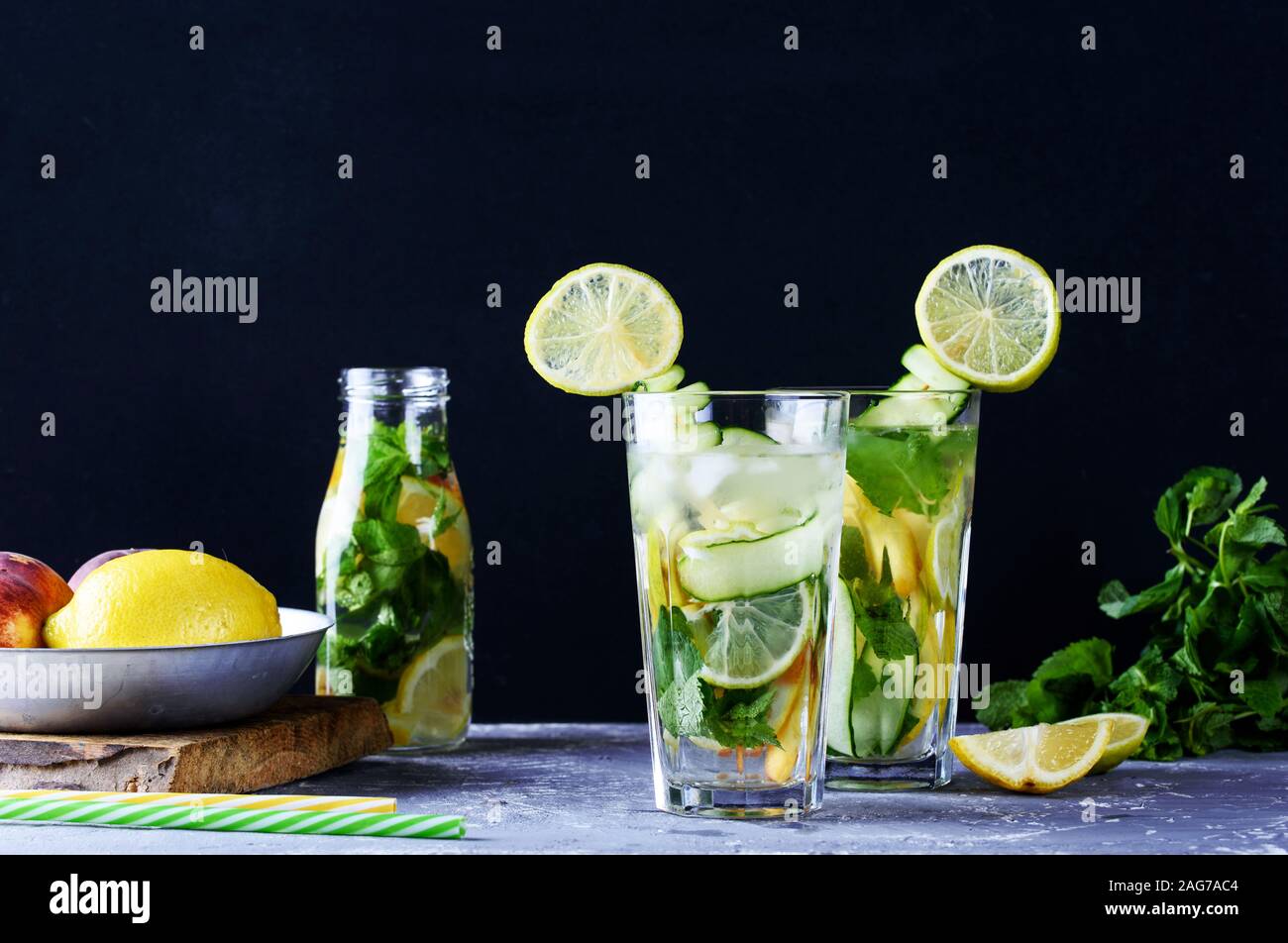 Delicious cool fruit lemonade. Fresh fruits and mint. Drink on a dark ...