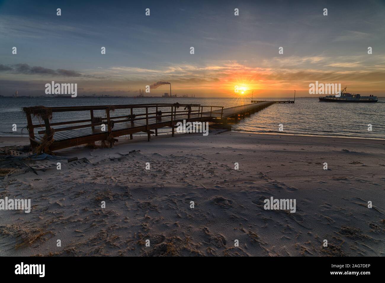Beautiful sunset over the pier at the beach creating the perfect ...