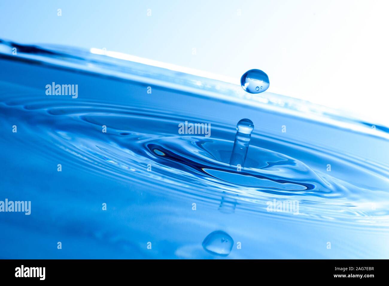 Water drop fall into water Stock Photo - Alamy