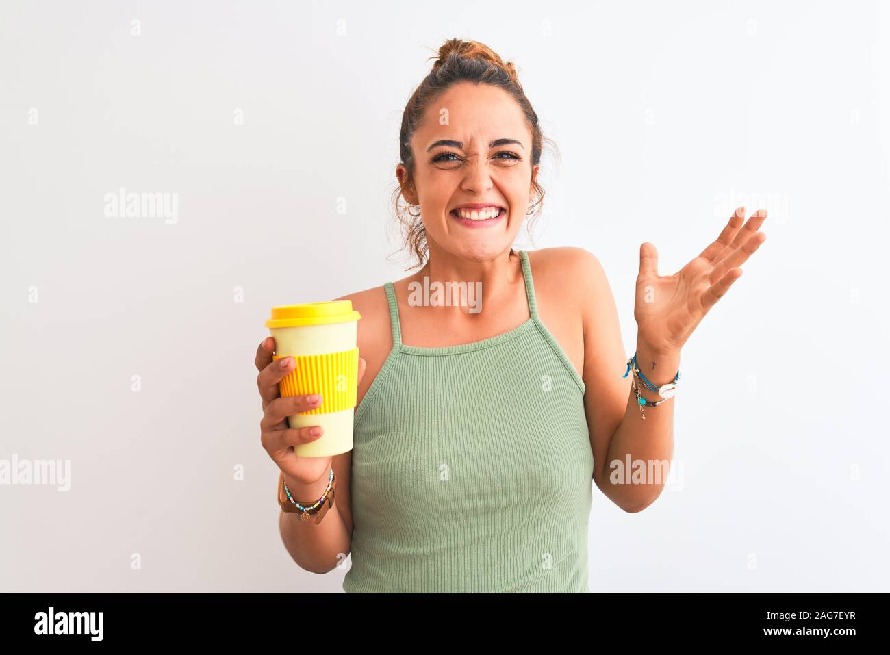 Young beautiful redhead woman drinking take away coffee over isolated ...