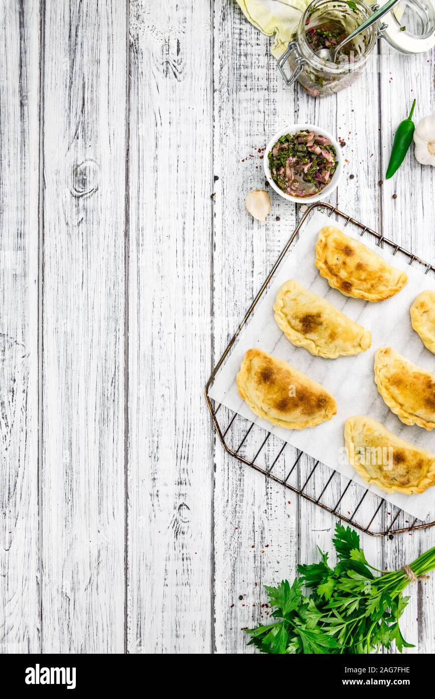 Wooden table with fresh homemade Empanadas (detailed close-up shot ...