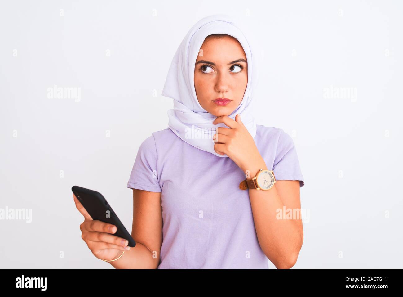 Young beautiful arabian girl wearing hijab using smartphone over ...