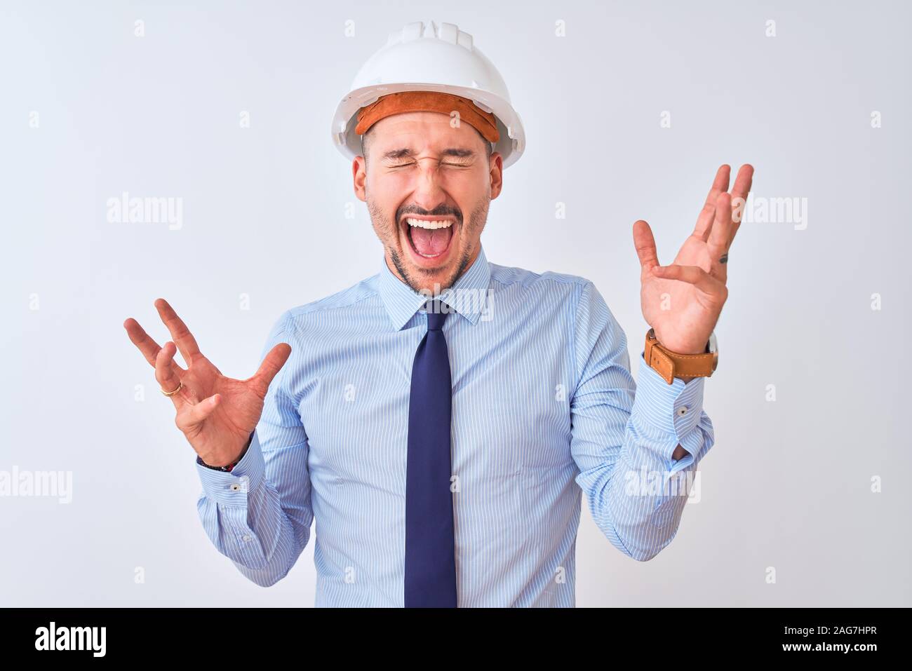 Young business man wearing contractor safety helmet over isolated ...