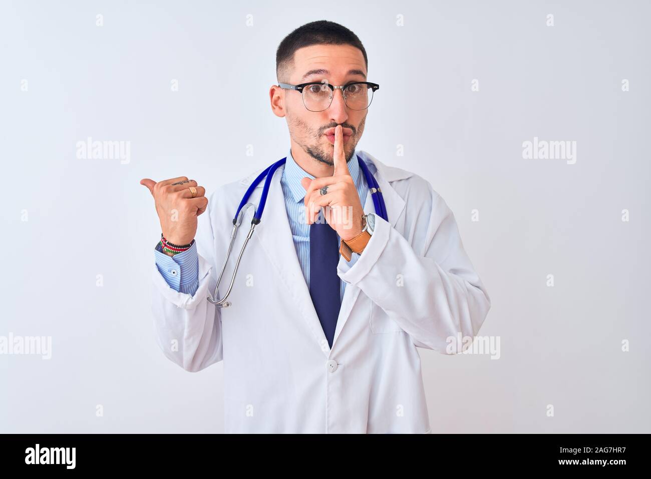 Young doctor man wearing stethoscope over isolated background asking to ...