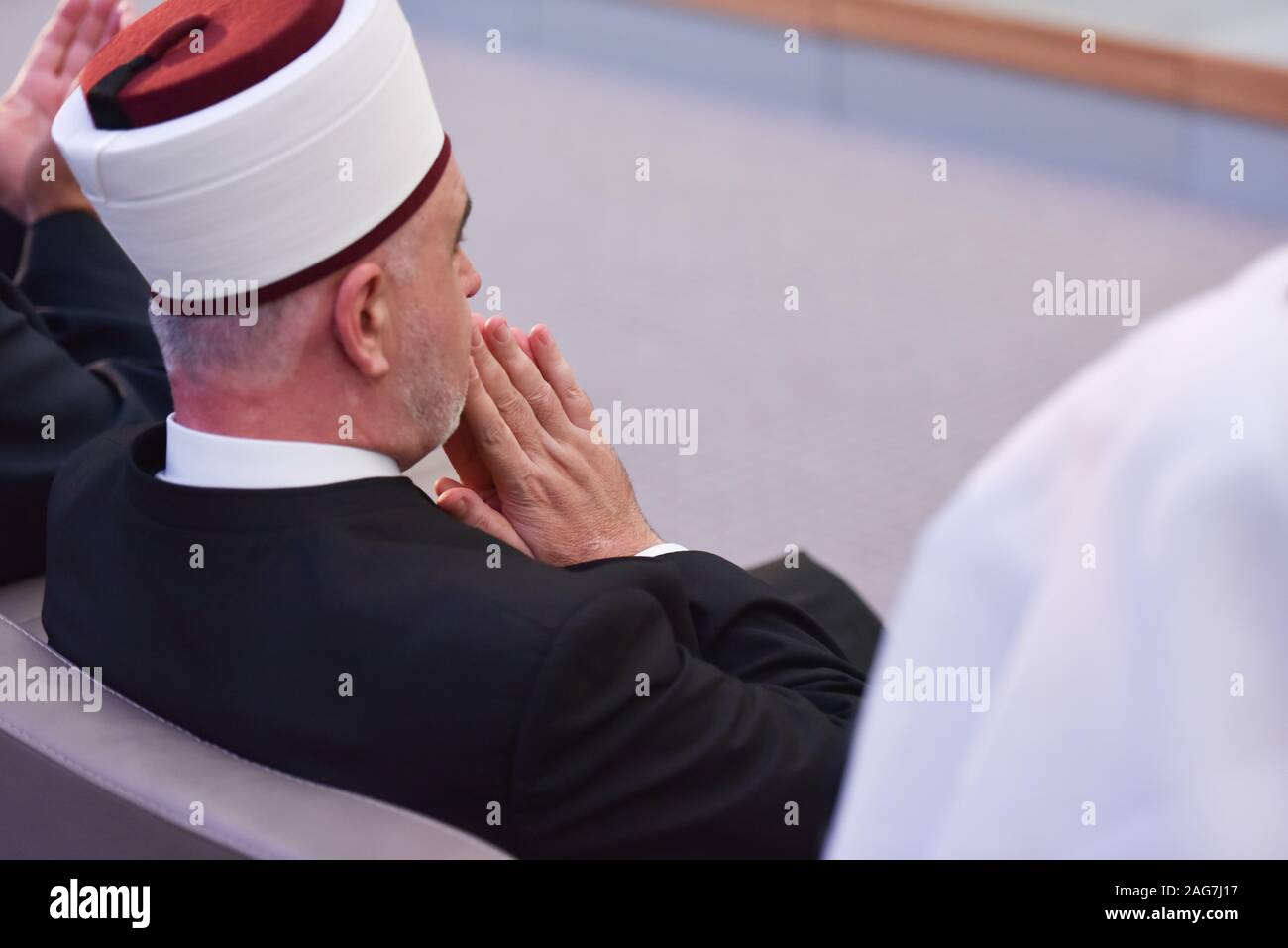 Elderly Muslim Arabic man praying during islamic conference Stock Photo ...