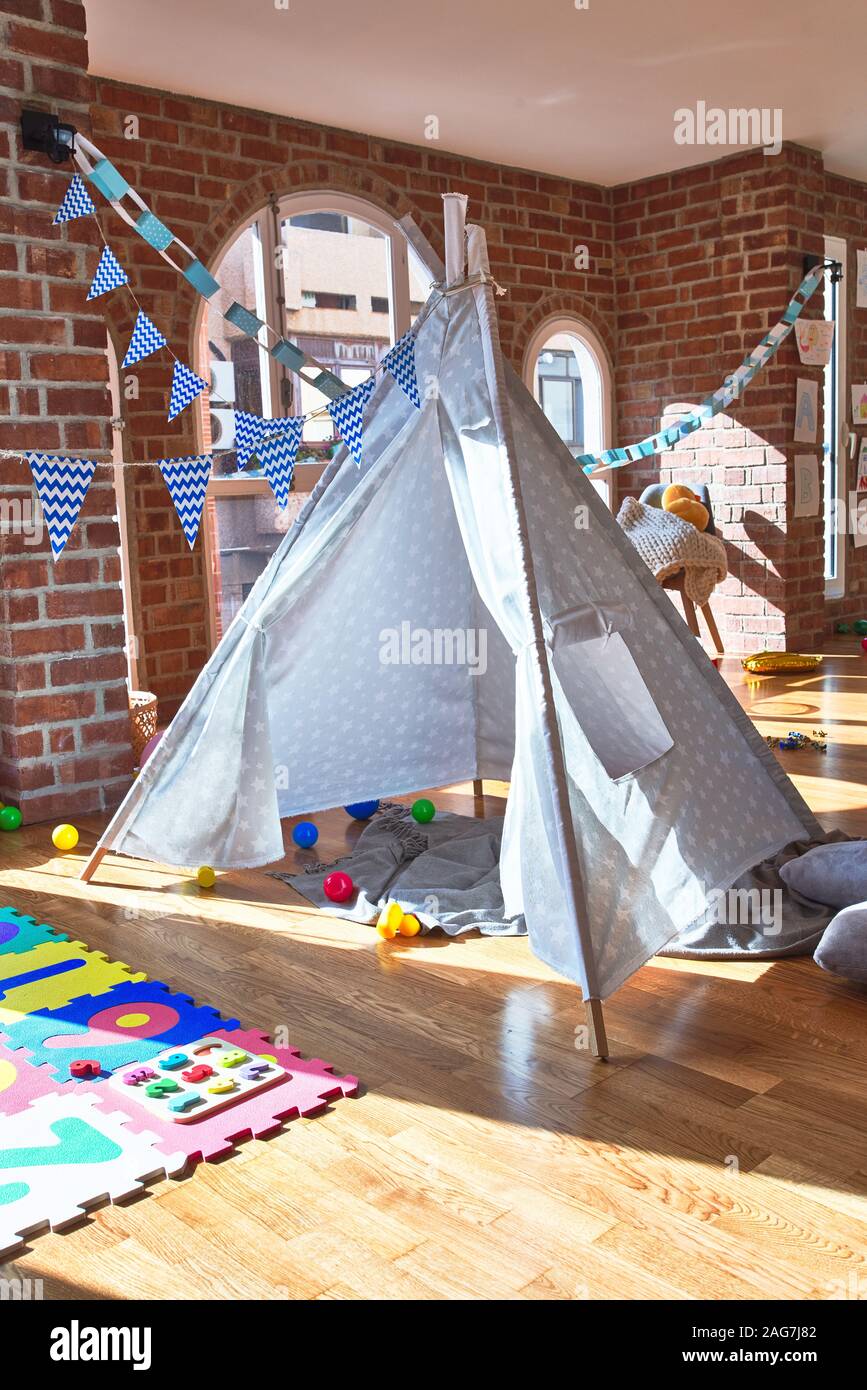 Picture of preschool playroom with colorful furniture and toys around ...
