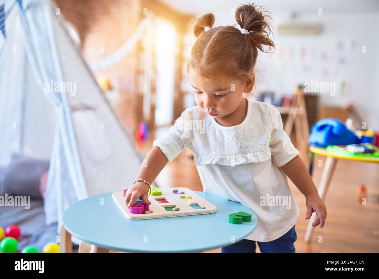 Young beautiful toddler learning mathematics playing with maths game at ...