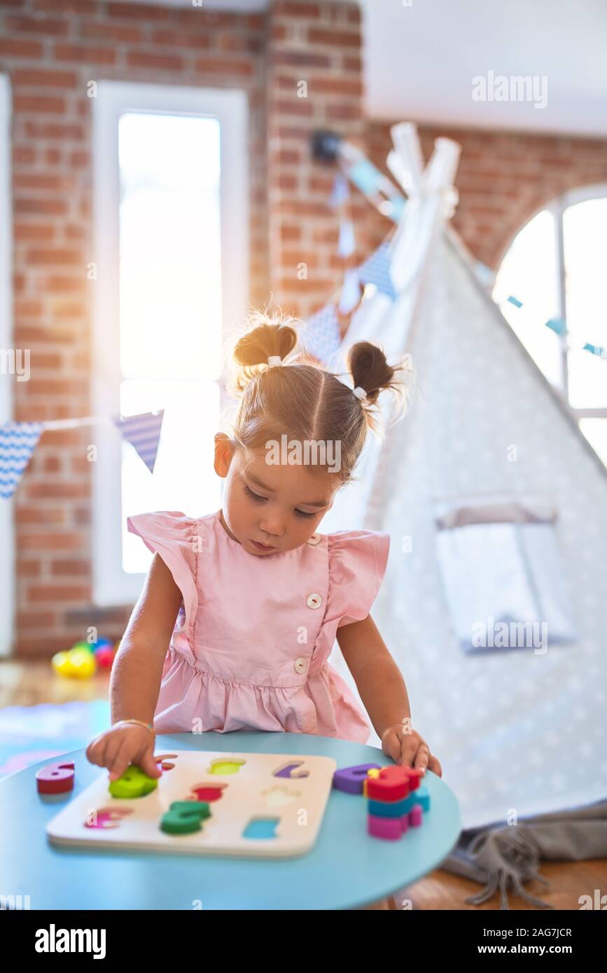 Young beautiful toddler learning mathematics playing with maths game at ...