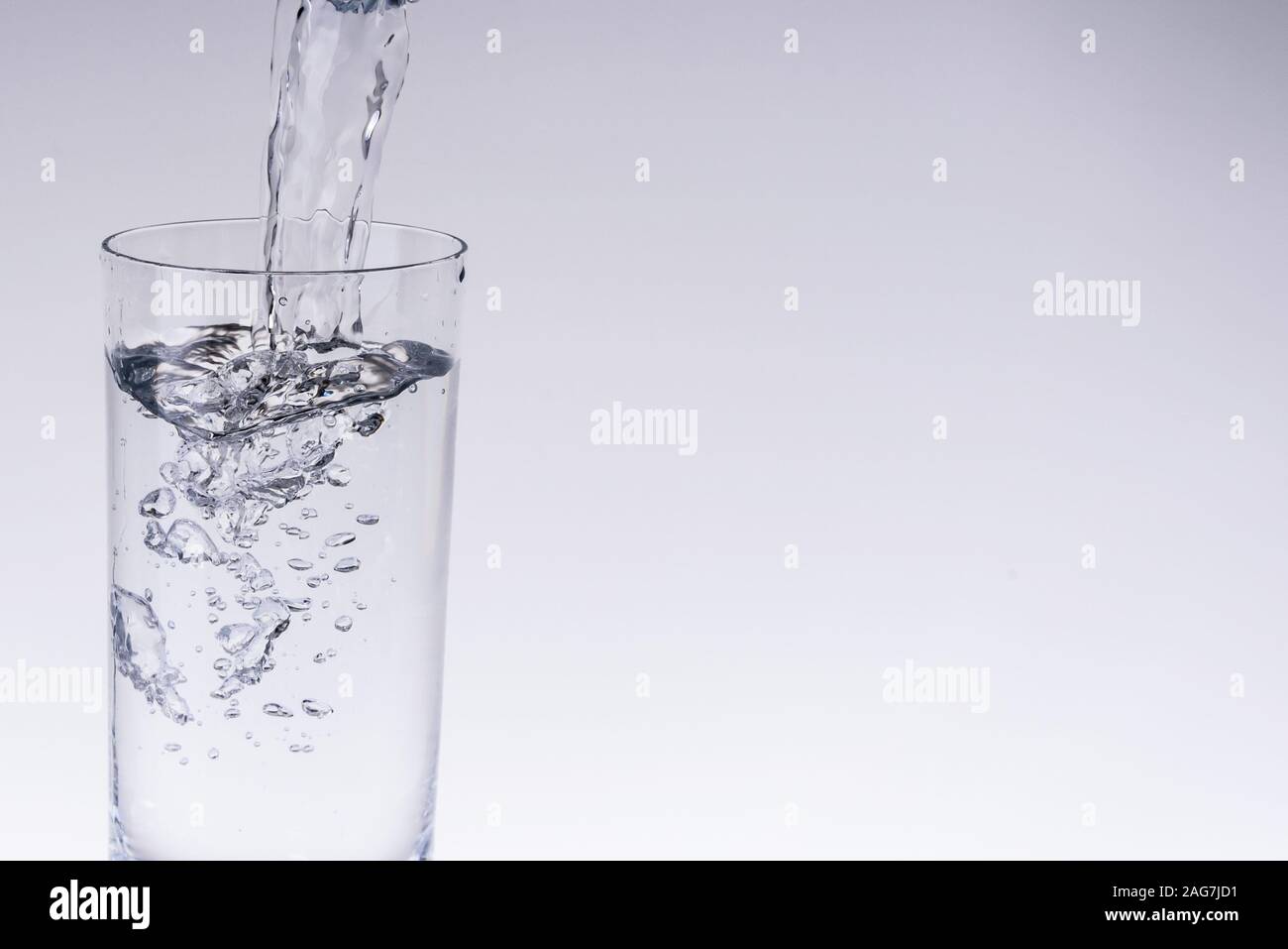 Filling up the water glass from water filter Stock Photo - Alamy