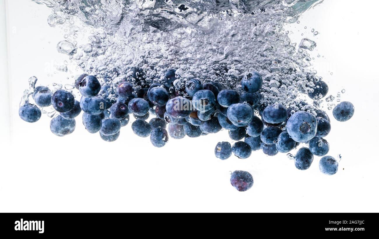 Blueberry’s splashing into crystal water Stock Photo - Alamy