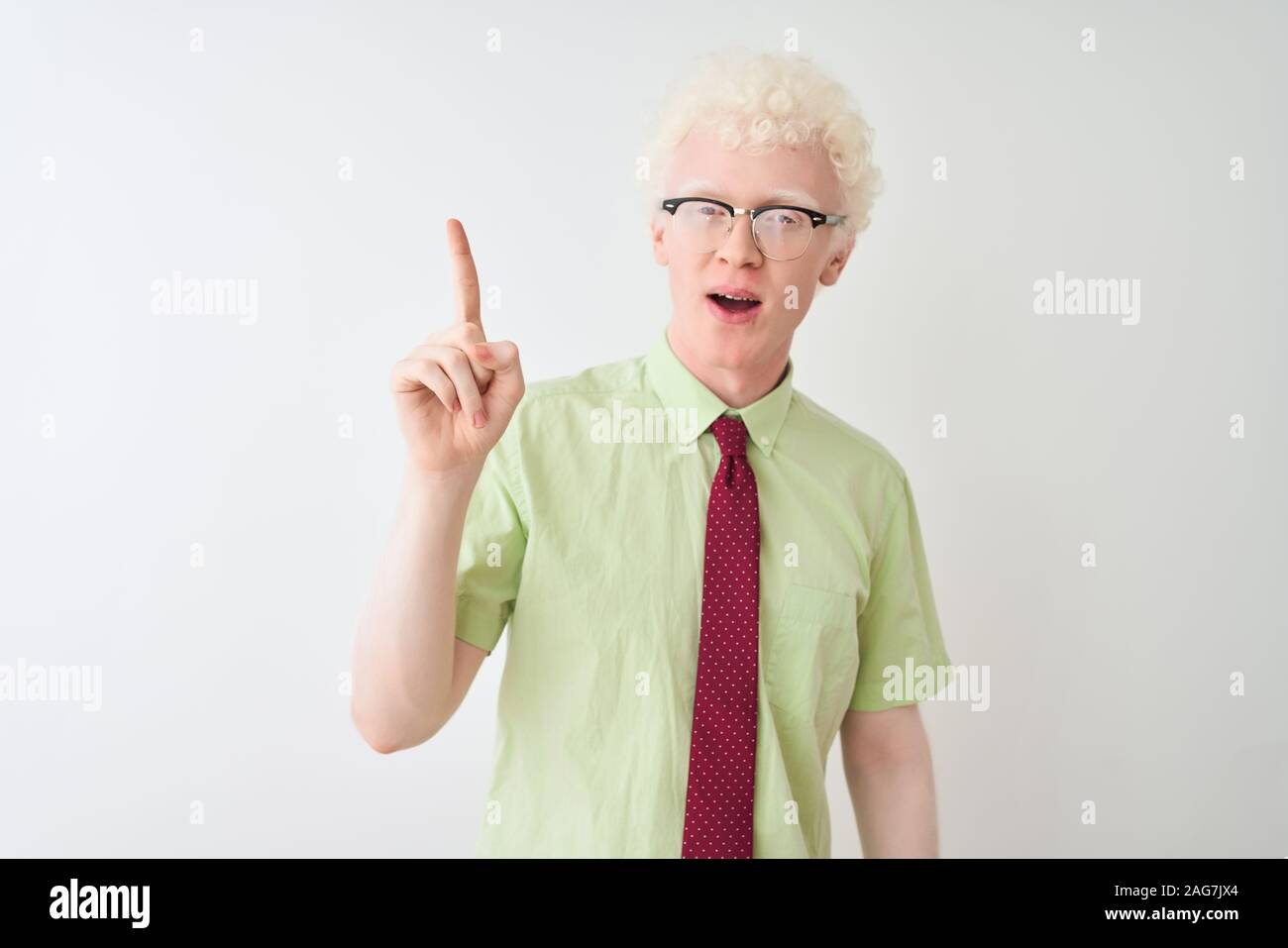 Young albino businessman wearing shirt and tie standing over isolated ...