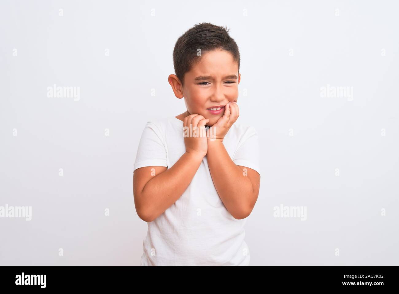 Beautiful kid boy wearing casual t-shirt standing over isolated white ...