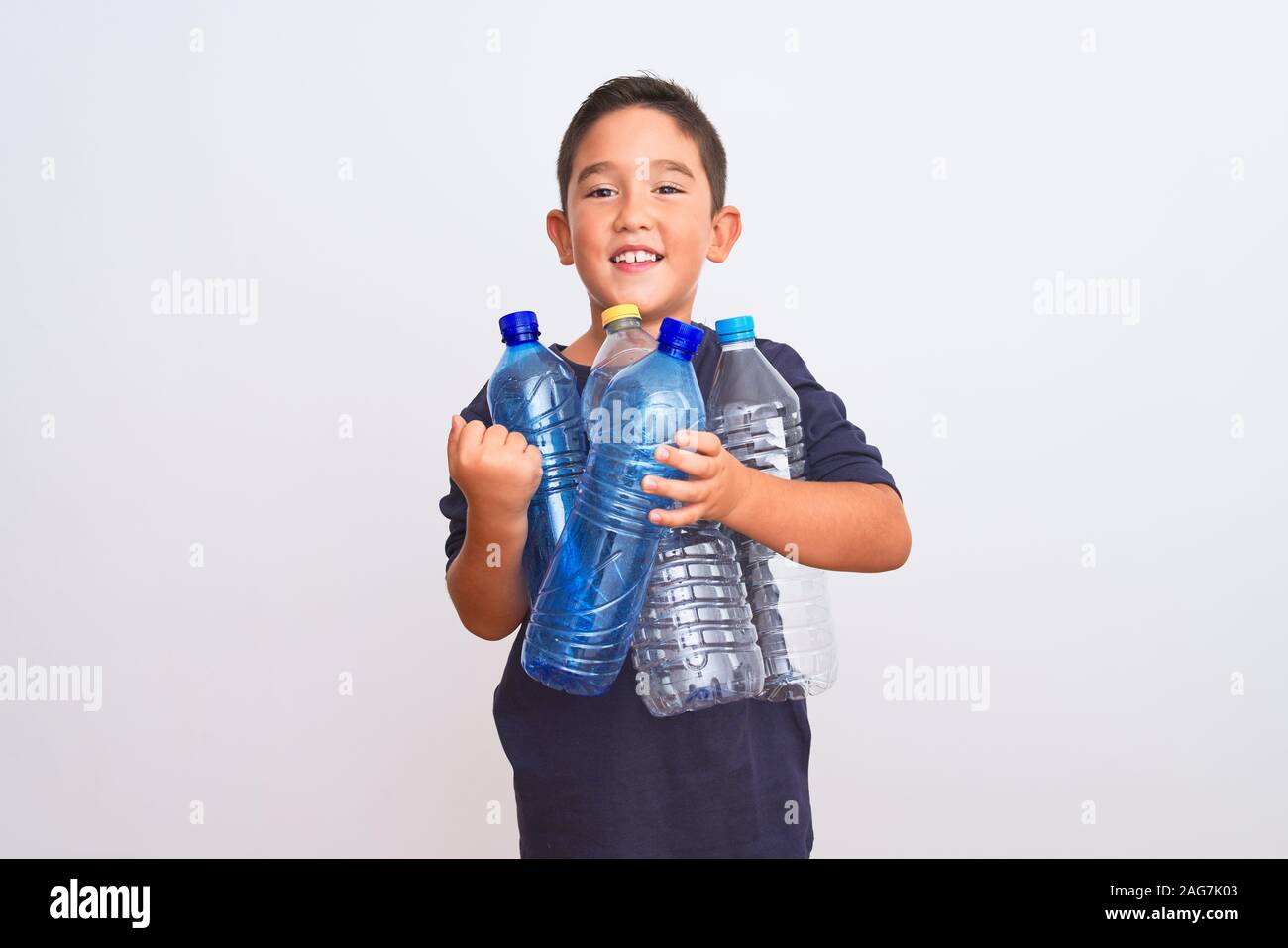 Beautiful kid boy recycling plastic bottles standing over isolated ...