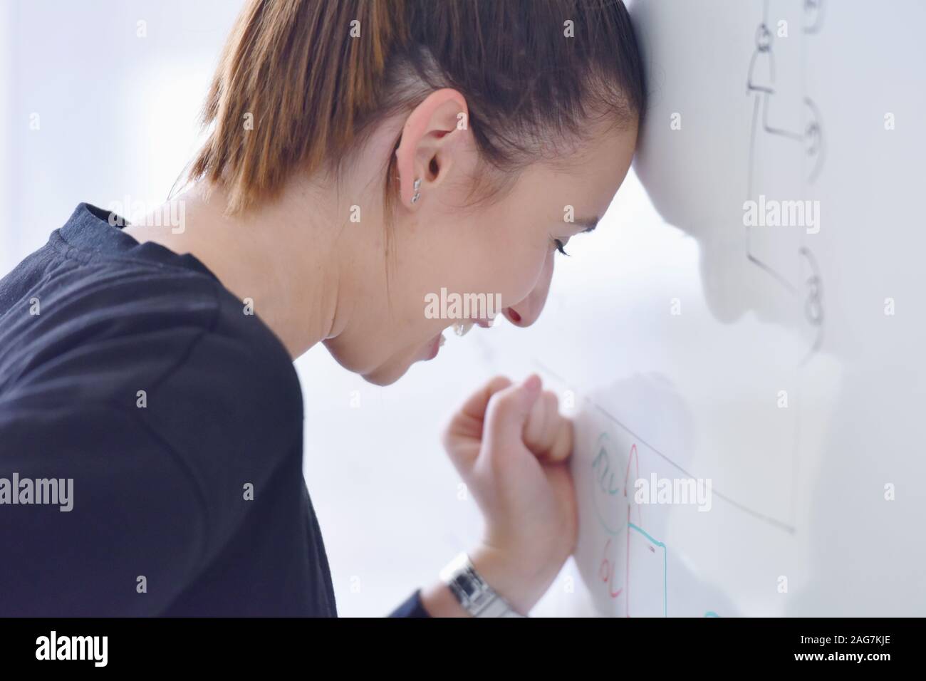 Young female student in math class overwhelmed by the math formula ...