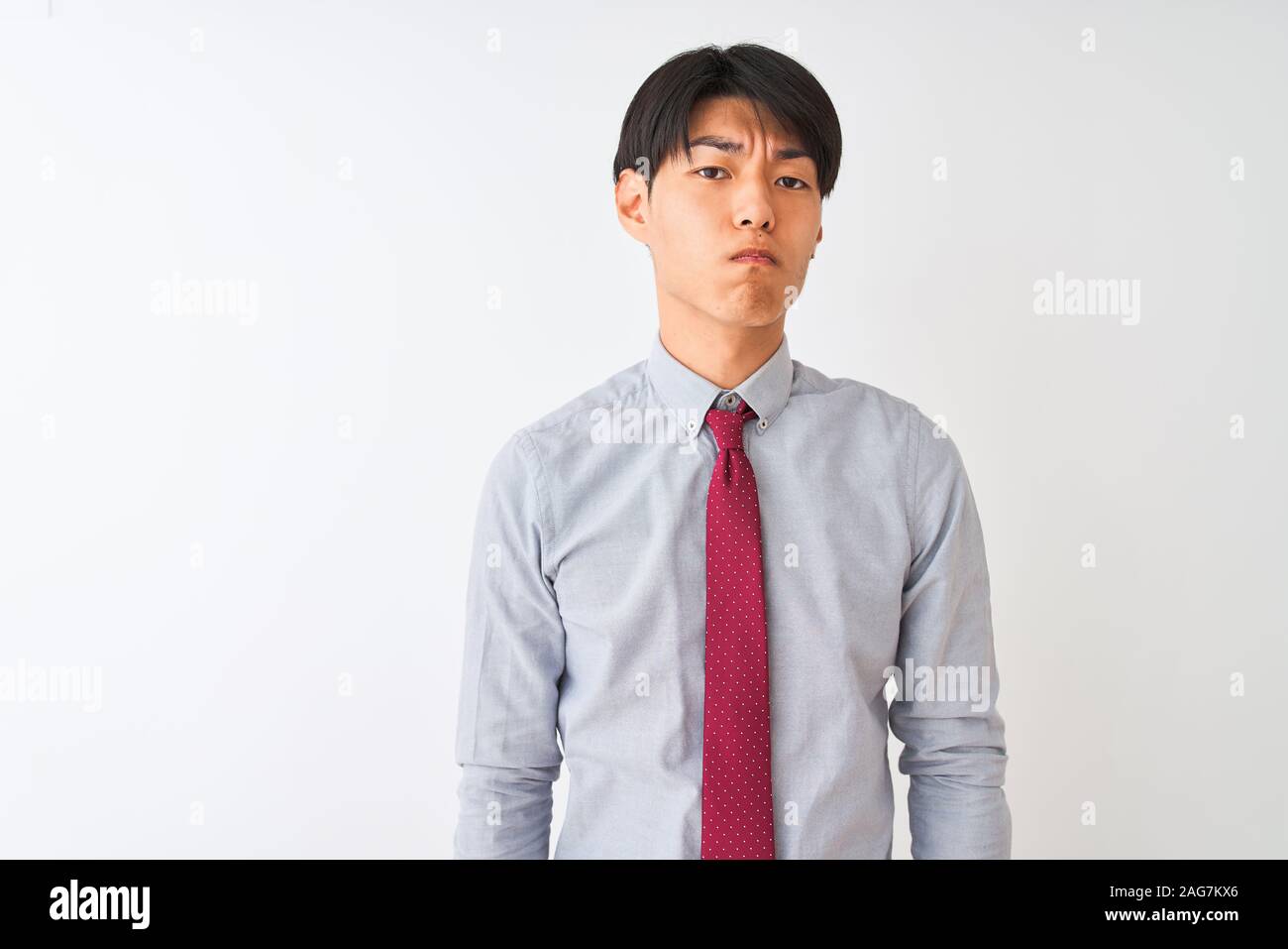 Chinese businessman wearing elegant tie standing over isolated white ...