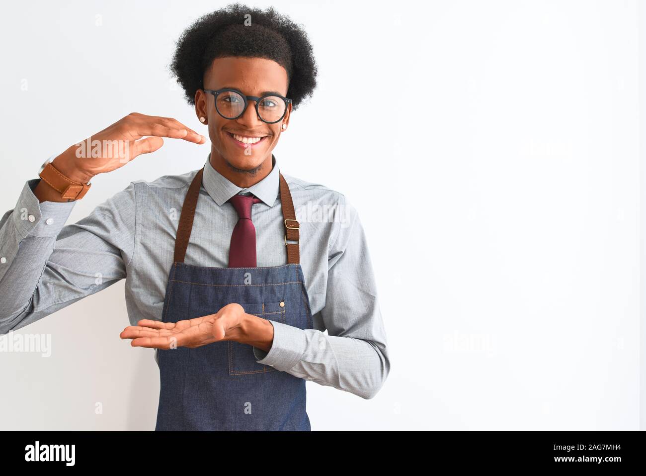 Young african american shopkeeper man wearing apron glasses over ...
