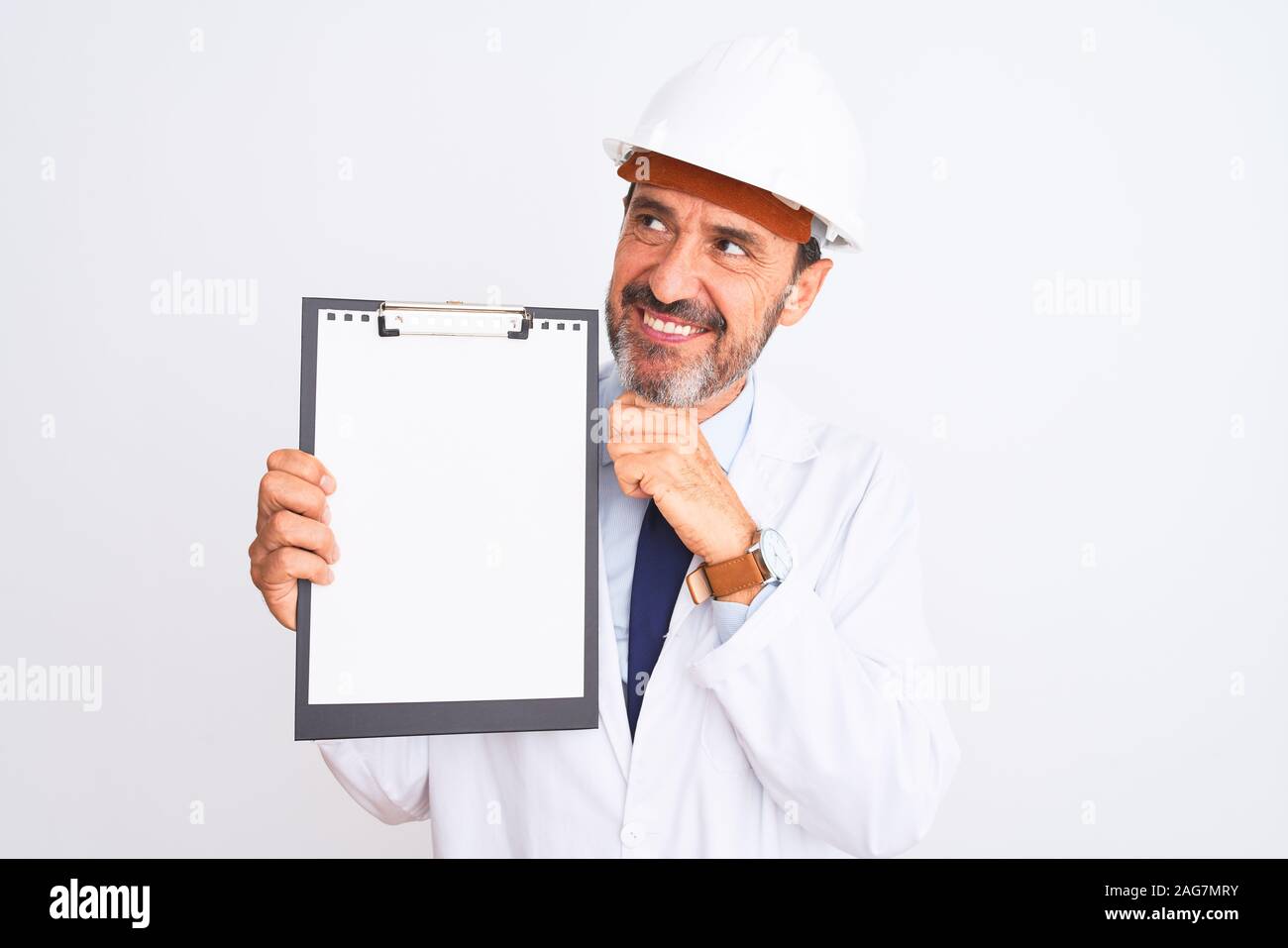 Senior engineer man wearing security helmet holding clipboard over ...