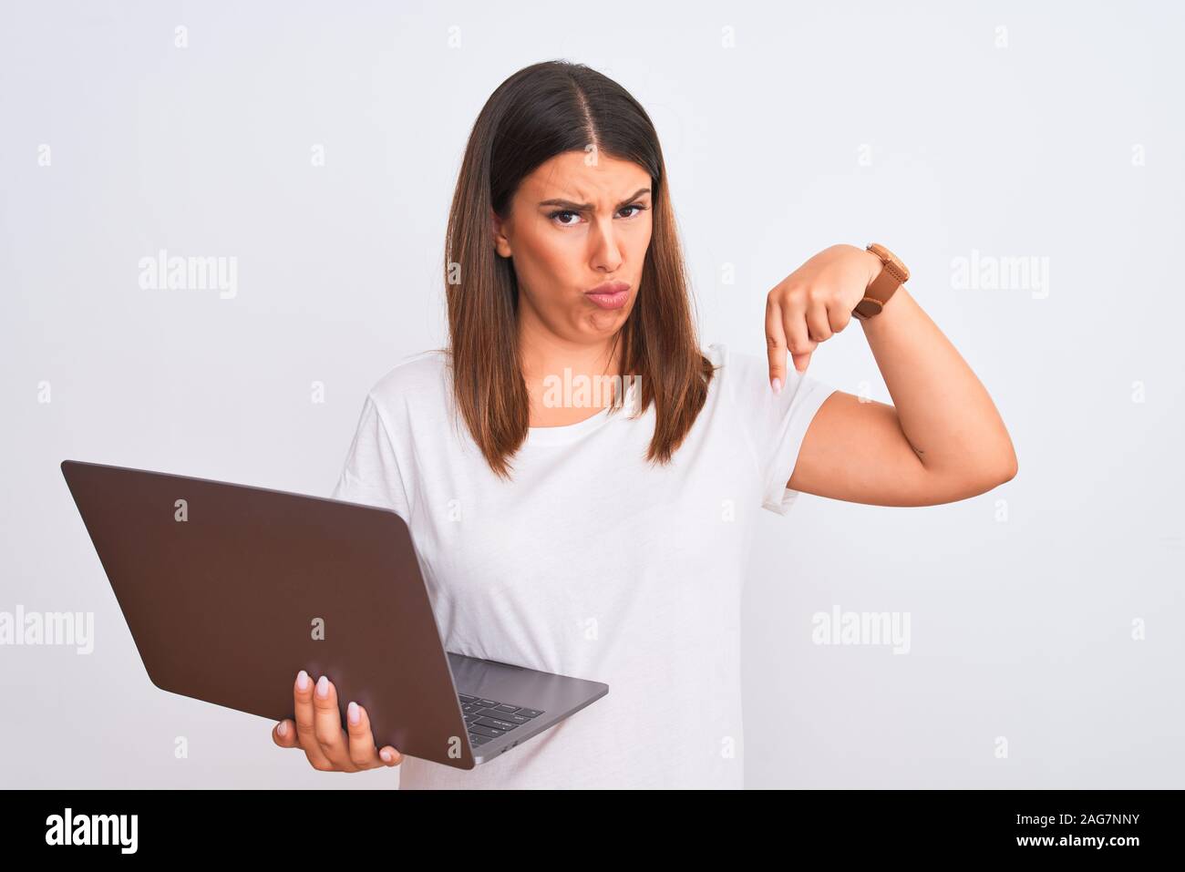 Beautiful young woman working using computer laptop over white ...
