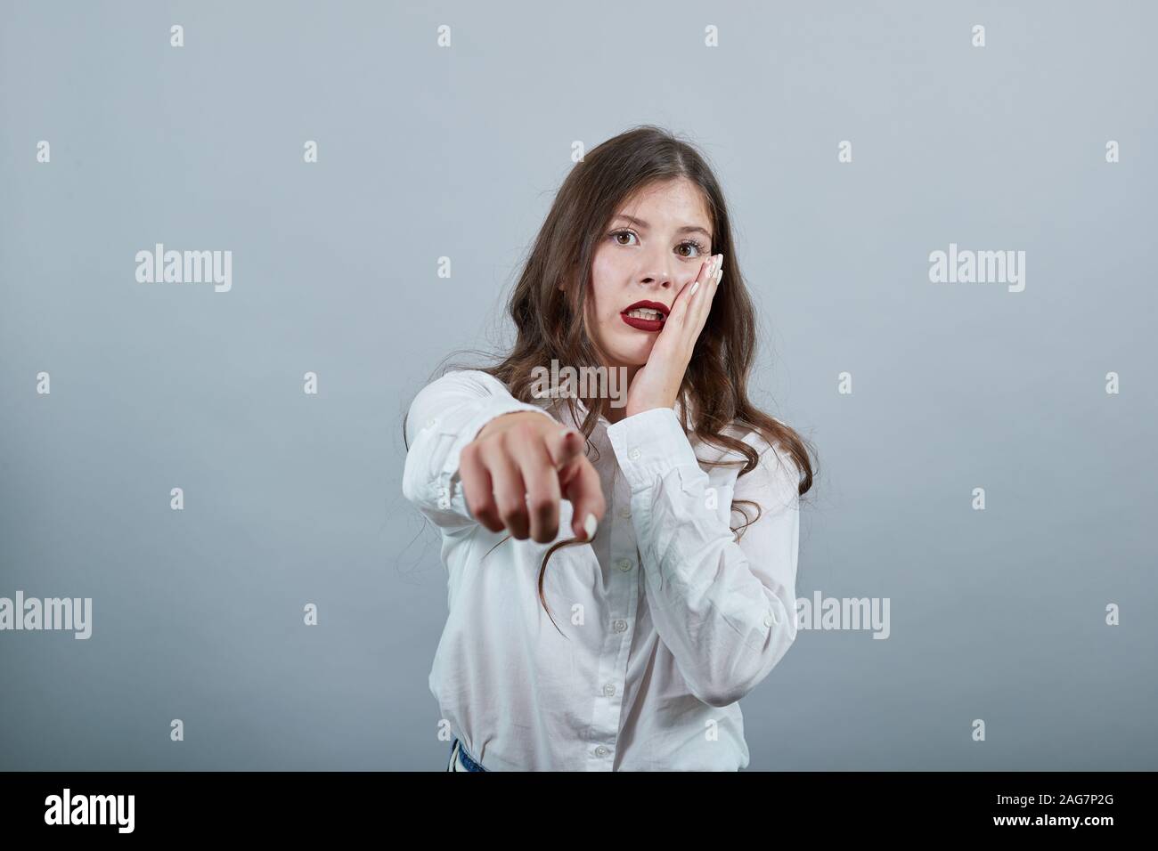 Beautiful woman pointing cheek hi-res stock photography and images - Alamy