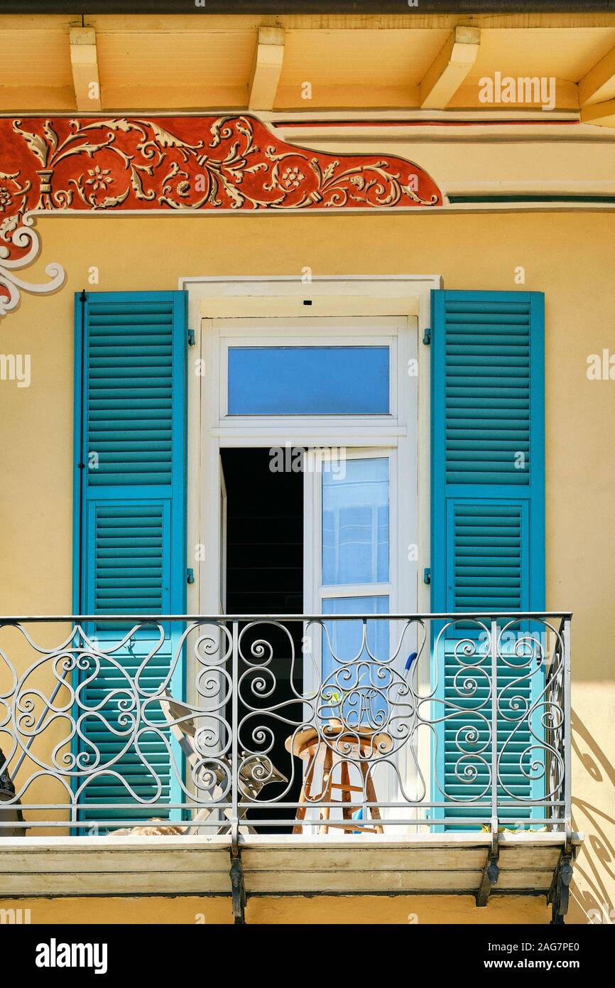 Vertical shot of a beautiful balcony with blue windows captured in ...