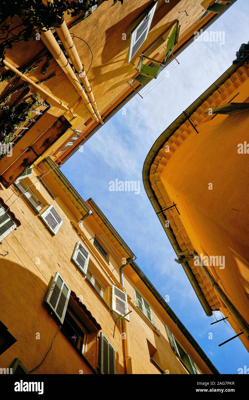 Vertical low angle shot of buildings under the blue sky captured in ...