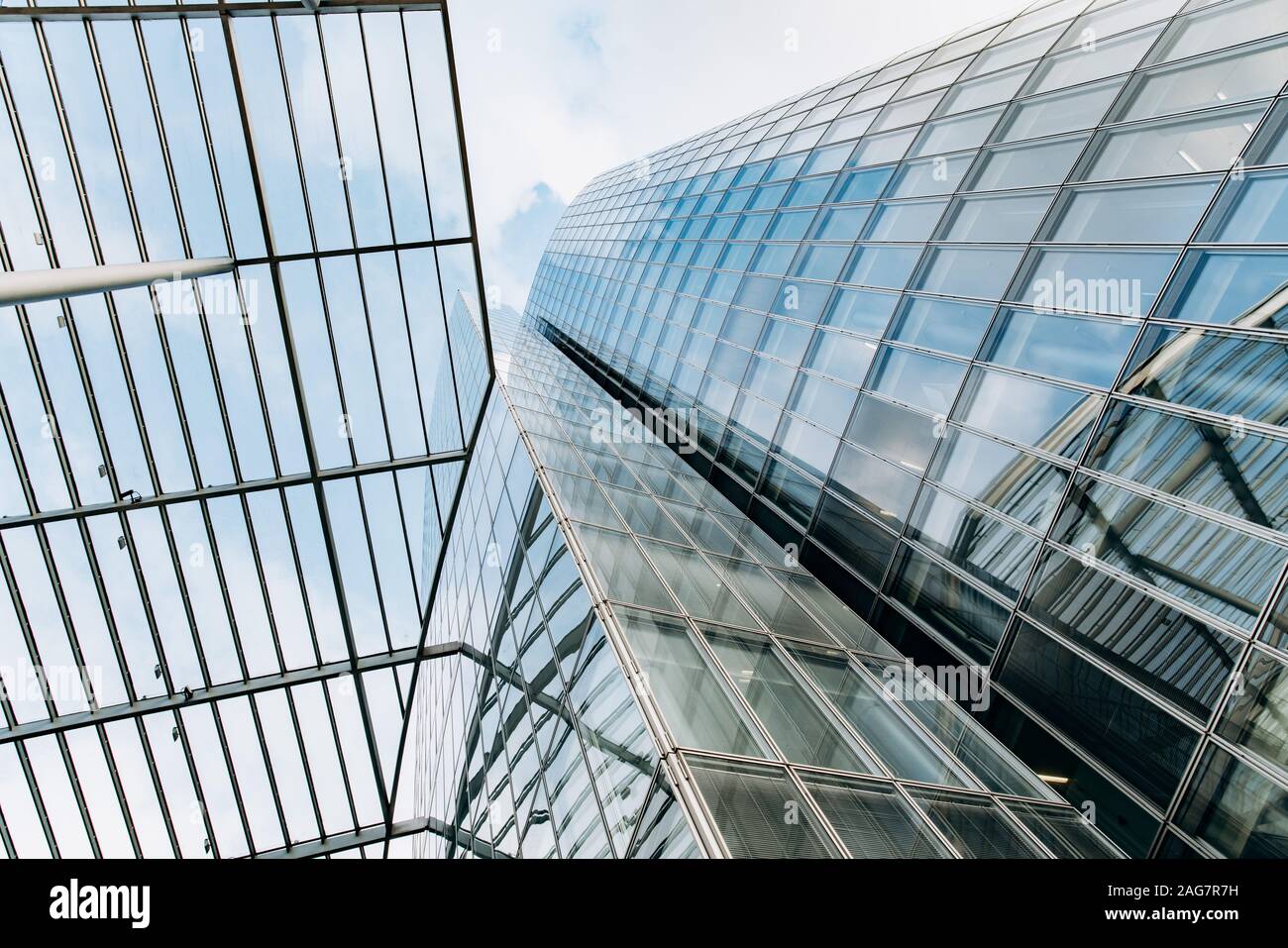 Reflection of the sky on a skyscraper. View of skyscrapers from below ...