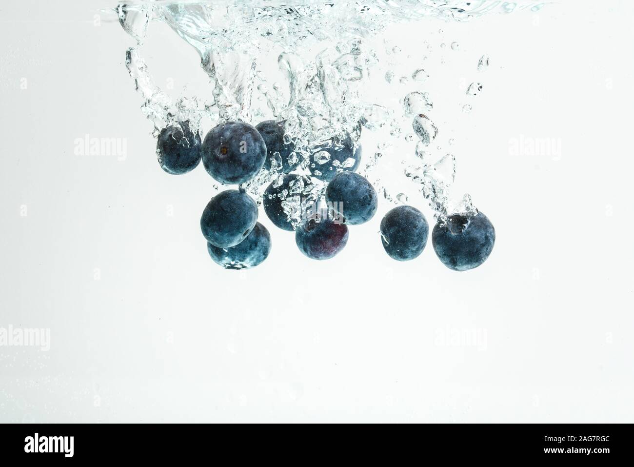 Blueberries falling into water Stock Photo - Alamy