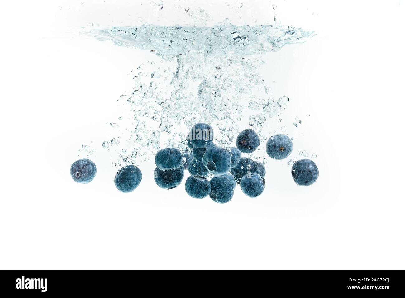 Blueberries falling into water Stock Photo - Alamy