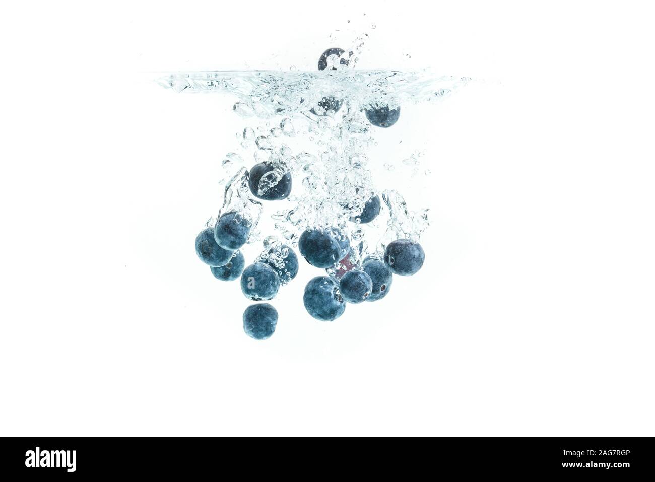 Blueberries falling into water Stock Photo - Alamy