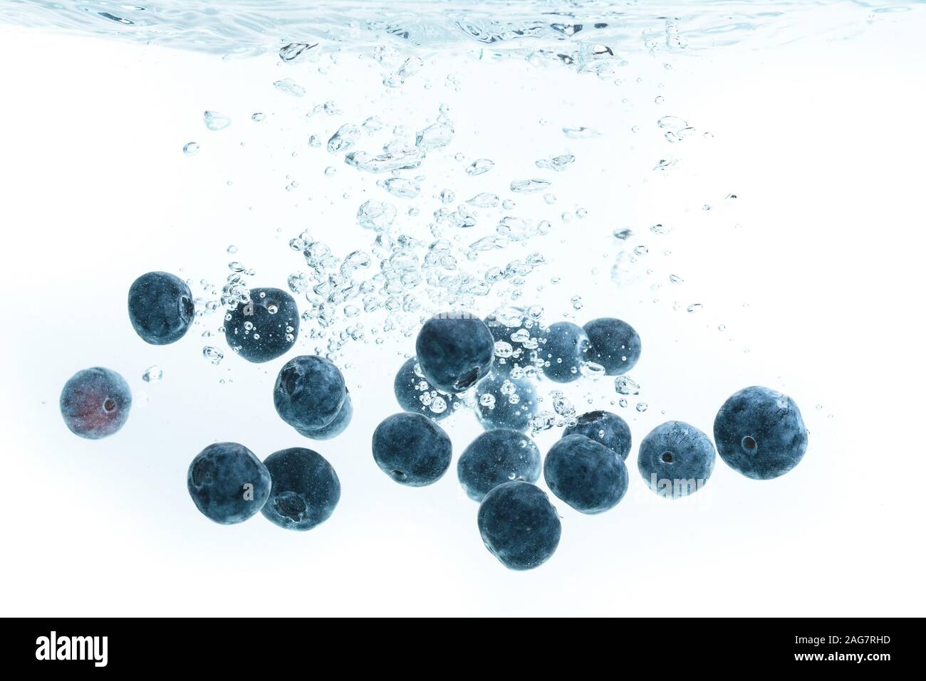 Blueberries falling into water Stock Photo - Alamy