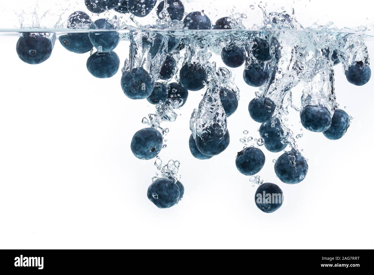 Blueberries falling into water Stock Photo - Alamy