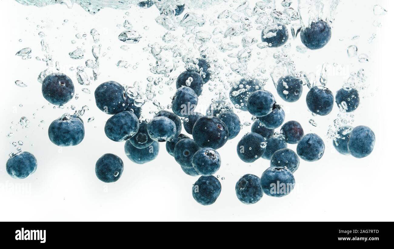 Blueberries falling into water Stock Photo - Alamy
