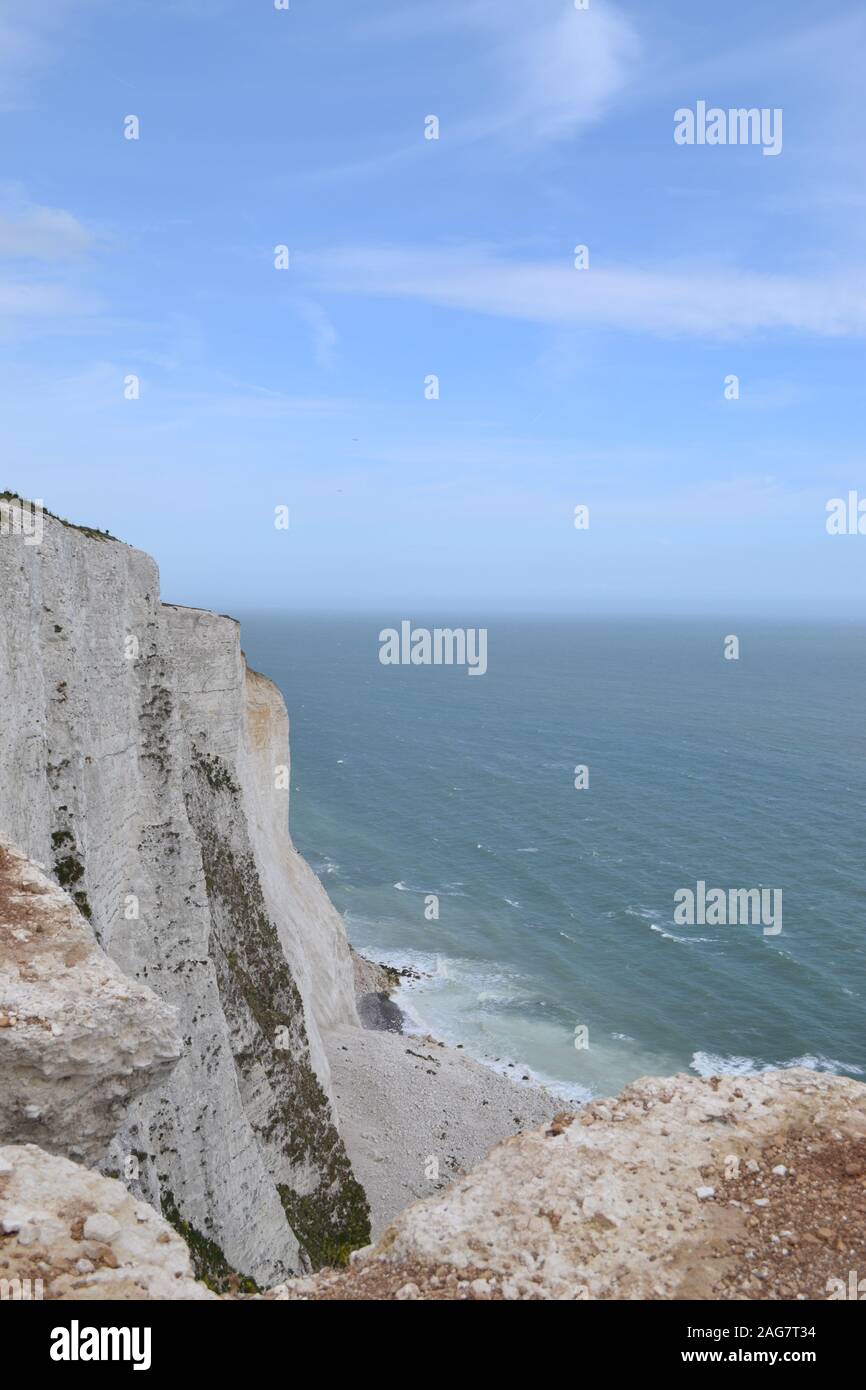 Vertical high angle shot of rocky cliffs near the sea in Dove, England ...