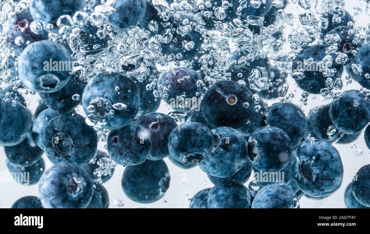 Blueberries falling into water Stock Photo - Alamy