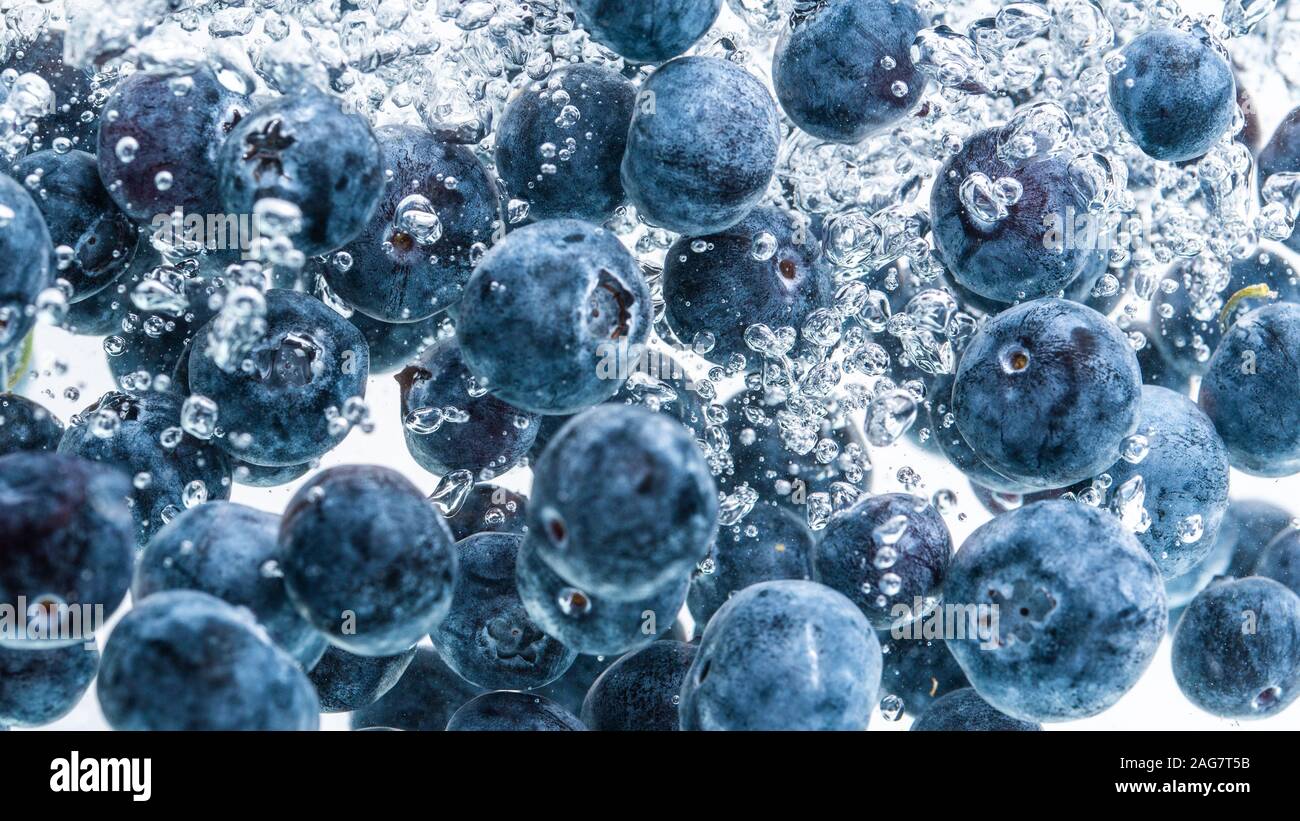 Blueberries falling into water Stock Photo - Alamy