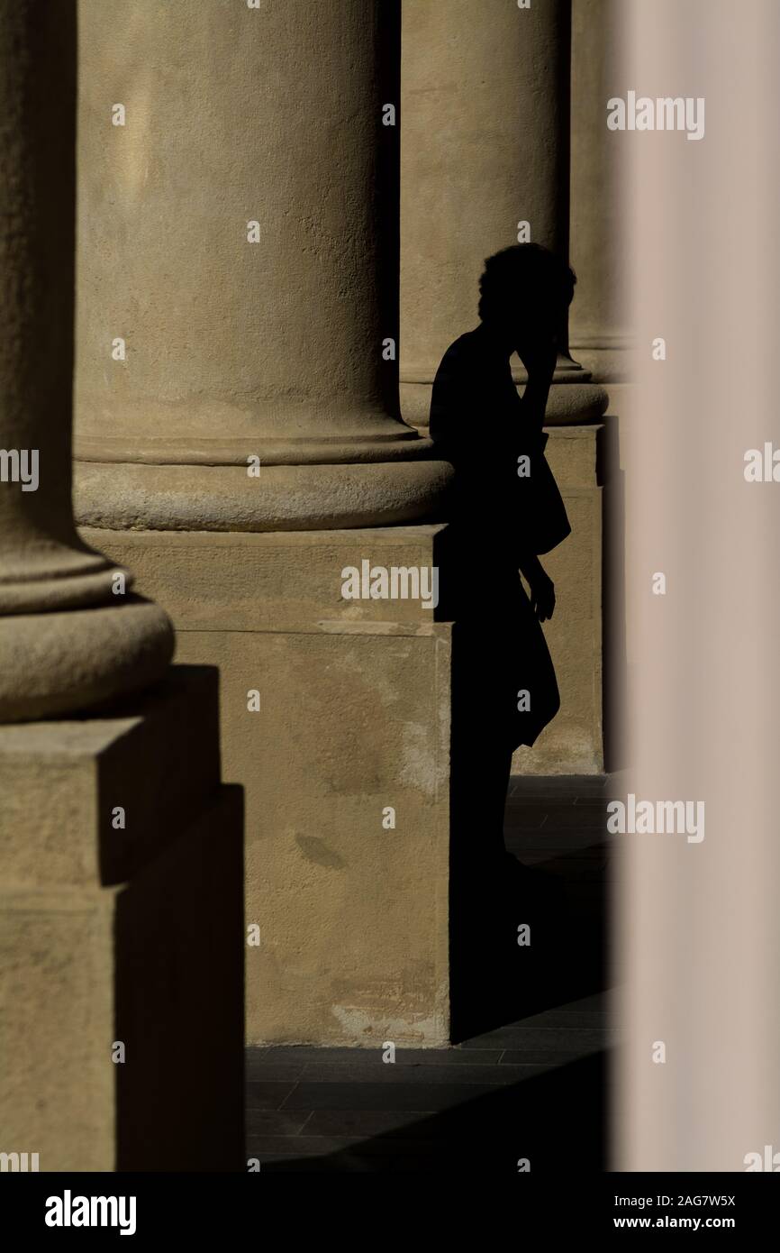 Vertical shot of a silhouette of a person standing in the middle of ...