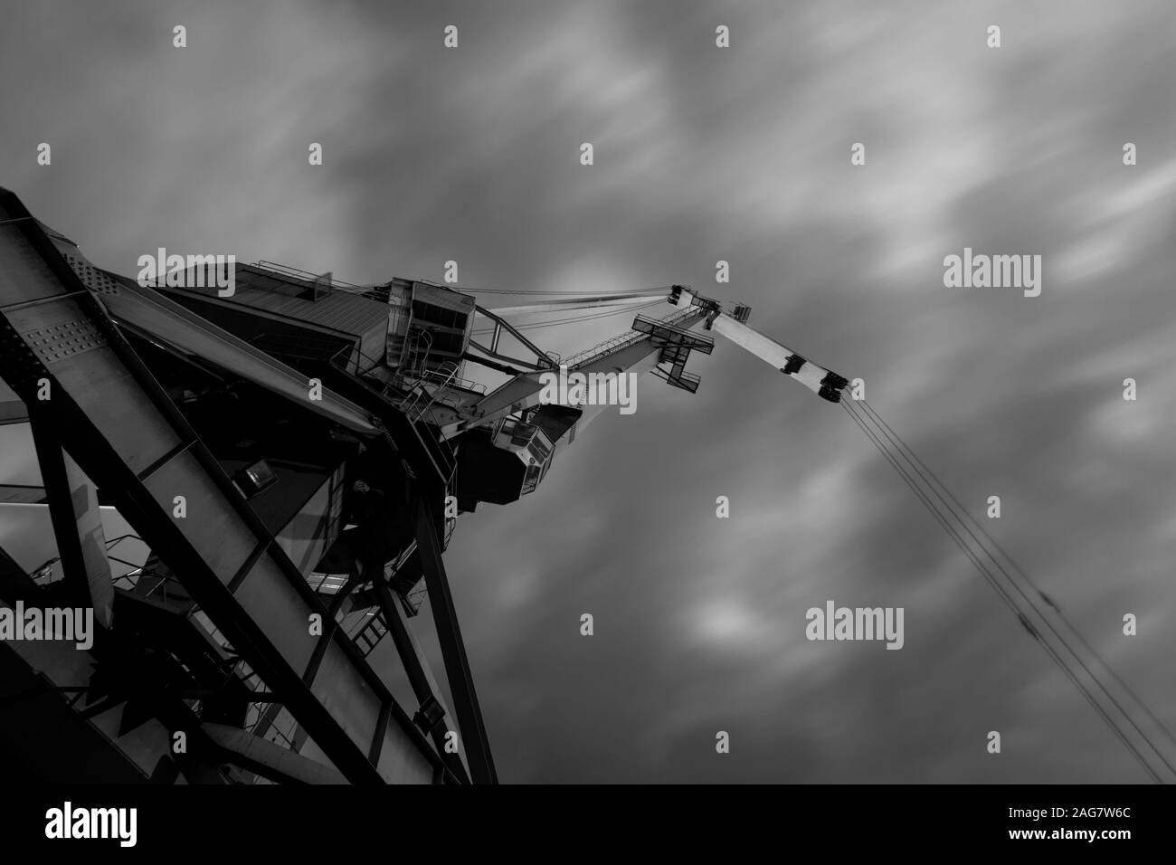 Low angle grayscale shot of a crane under the gloomy sky Stock Photo ...