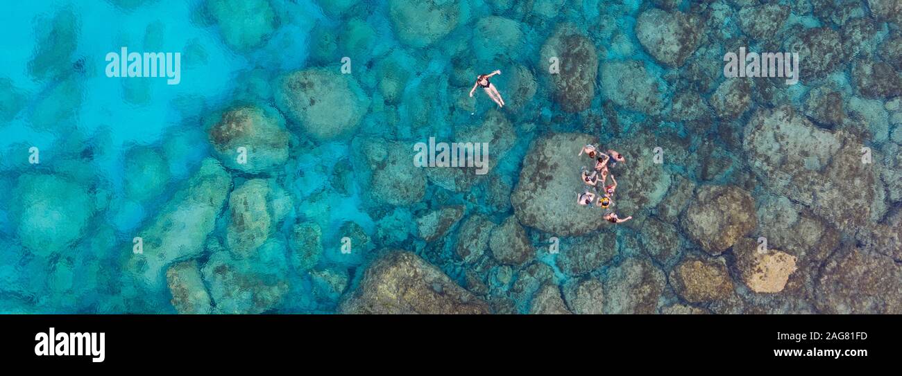 Aerial panoramic shot of a group of people swimming in the ...