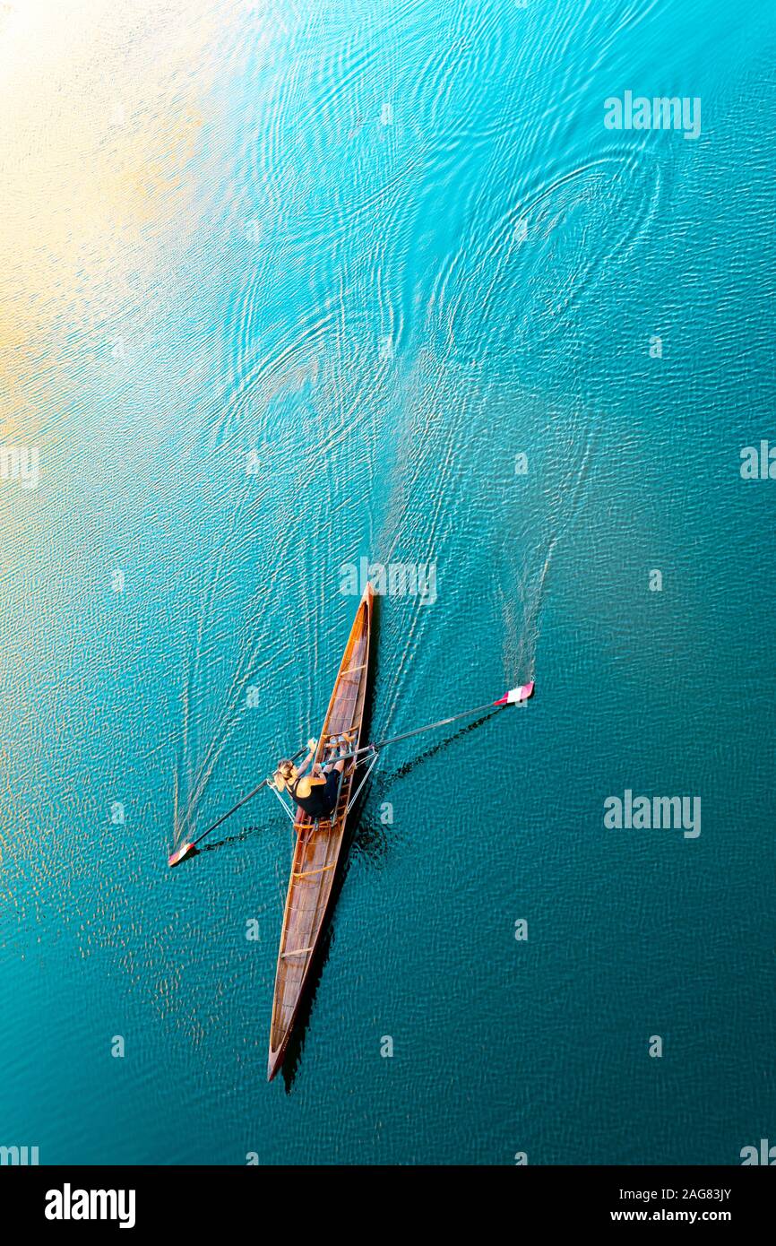 Vertical high angle shot of a boat rowing floating in the sea and ...