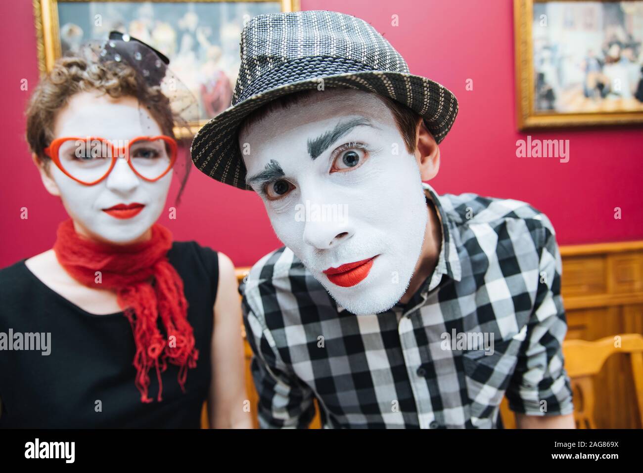 two mimes showing emotions on the wall background Stock Photo - Alamy