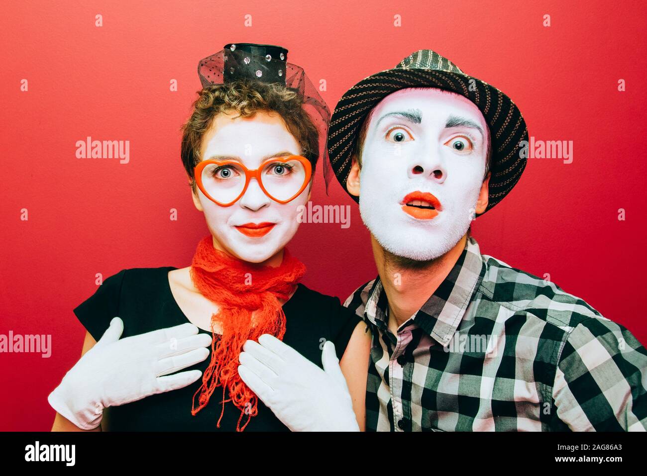 two mimes showing emotions on the wall background Stock Photo - Alamy