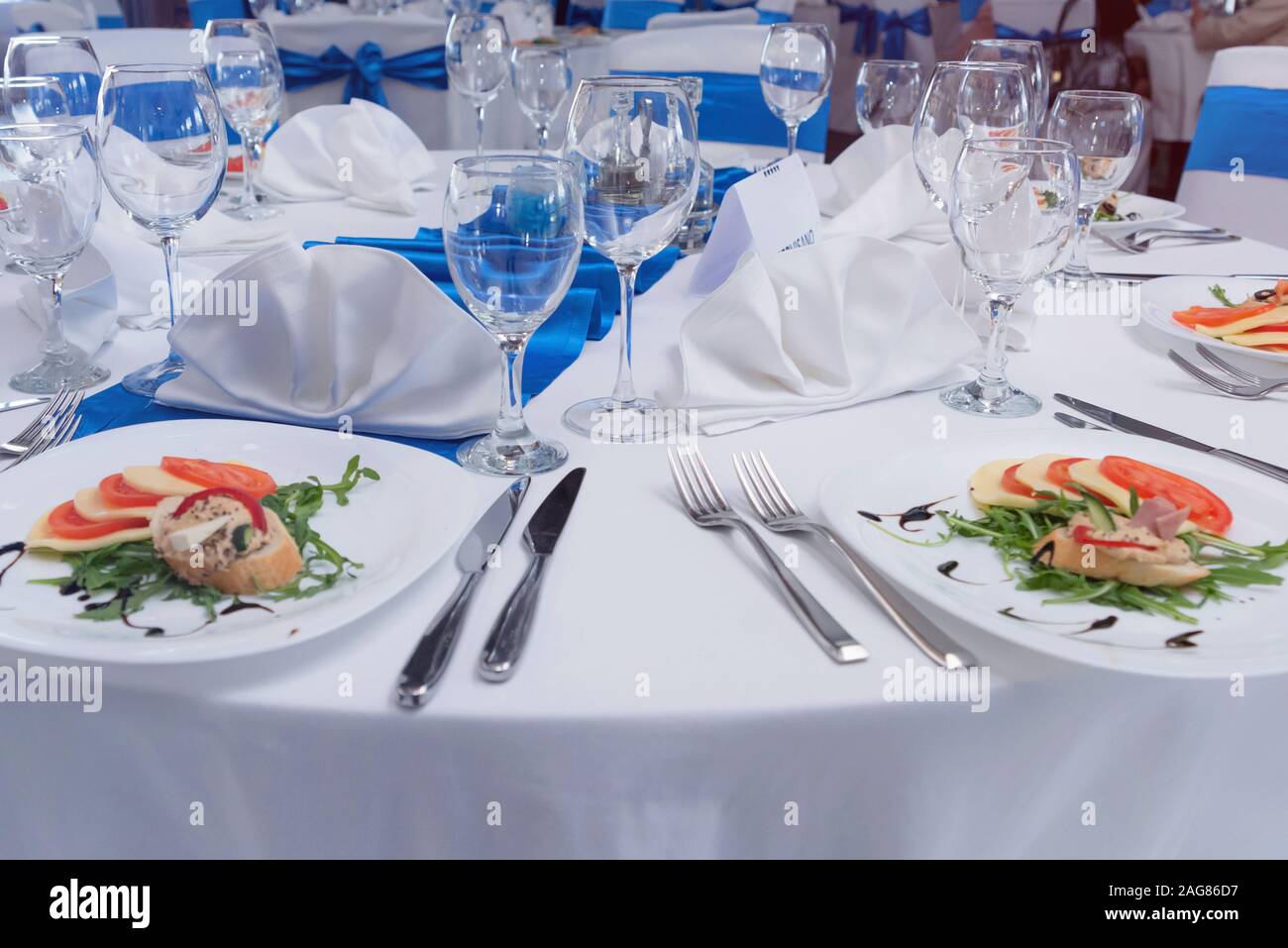 Tables and chairs in the restaurant with food and full set preparation ...